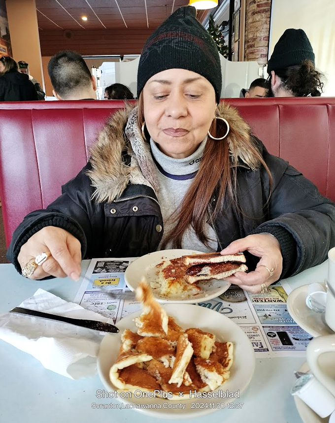 A patron enjoying what appears to be French toast—the kind of breakfast that makes you want to high-five the cook on your way out.