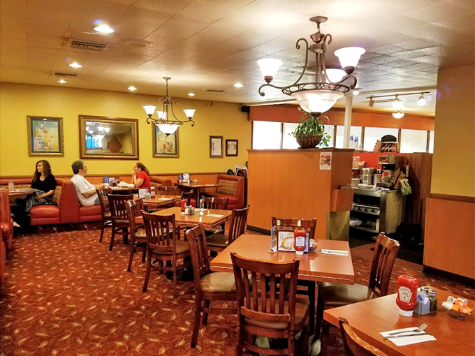 The dining room hums with conversation and silverware clinks, where chandeliers cast a warm glow that makes everyone look like they're in a Norman Rockwell painting.