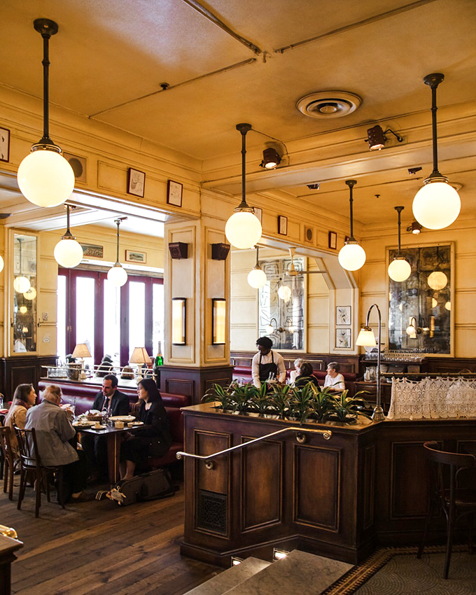 The globe pendant lights cast a golden glow over diners, creating that magical "we're not in Philadelphia anymore" feeling.