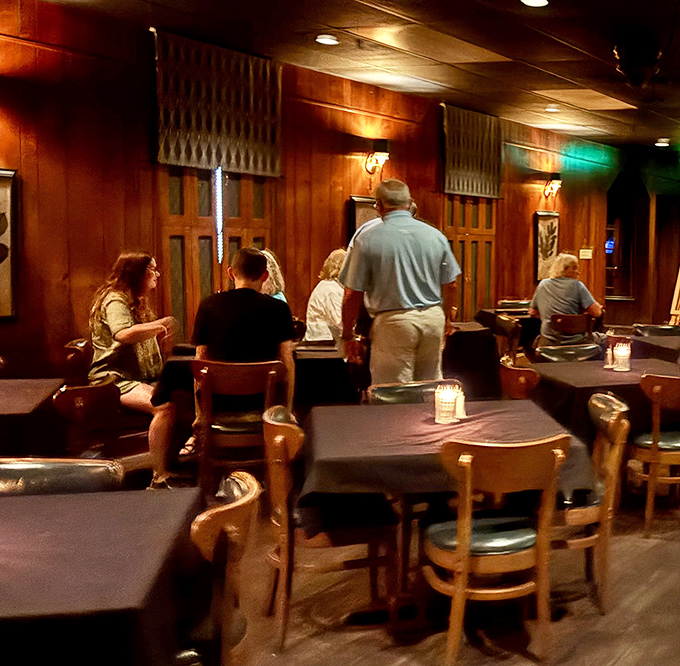 The warm wood-paneled dining room buzzes with conversation and anticipation&mdash;these diners know they're in for something special tonight.