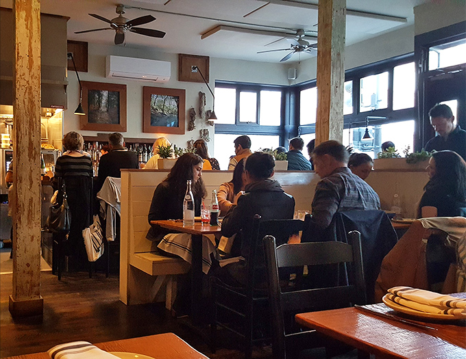 Happy diners who've discovered that yes, sardines on chips actually make perfect sense after all.