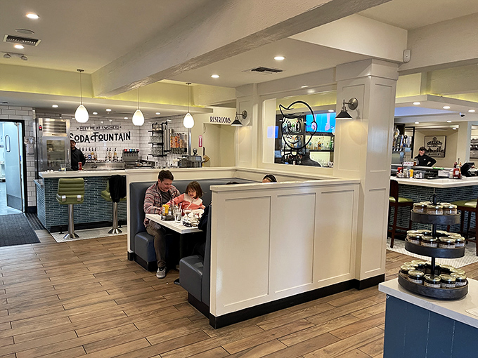 Family moments unfold in cozy booths while the nostalgic soda fountain beckons in the background &ndash; some traditions are worth preserving.