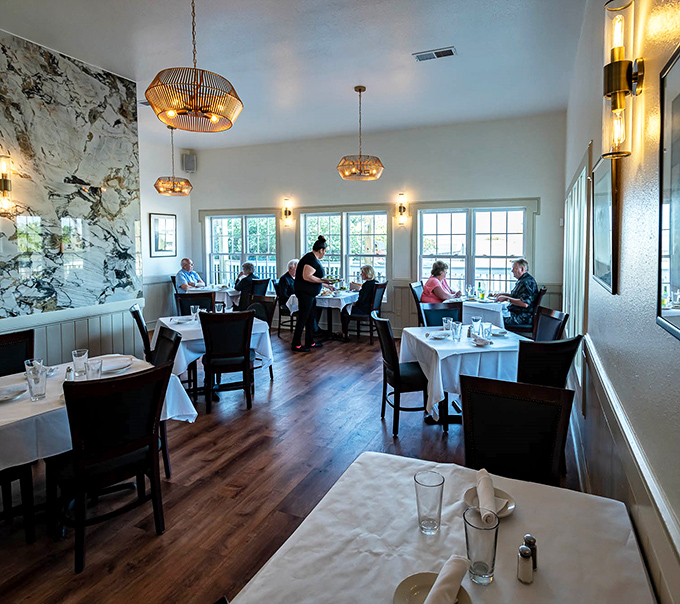 The dining room hums with the satisfied murmurs of patrons who just discovered their new favorite restaurant. White tablecloths say "special" without shouting "stuffy."