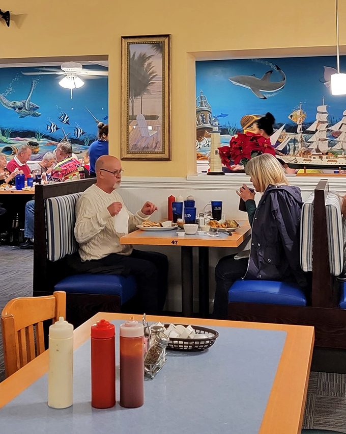 Blue Ocean's dining room: where conversations flow as freely as the sweet tea. Those nautical murals make every meal feel like a mini-vacation.