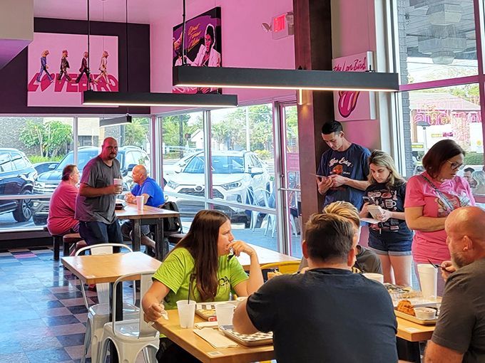 The dining room buzzes with the universal language of "mmm" as strangers become united in crispy chicken brotherhood.