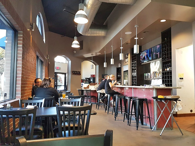 The bar area where strangers become friends over shared sauce stains. Nothing builds community quite like collectively abandoning proper eating etiquette.