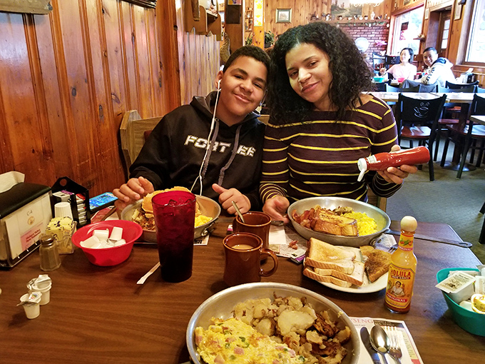 The universal language of breakfast joy&mdash;shared across a table laden with skillets of morning perfection. Some traditions are worth preserving.