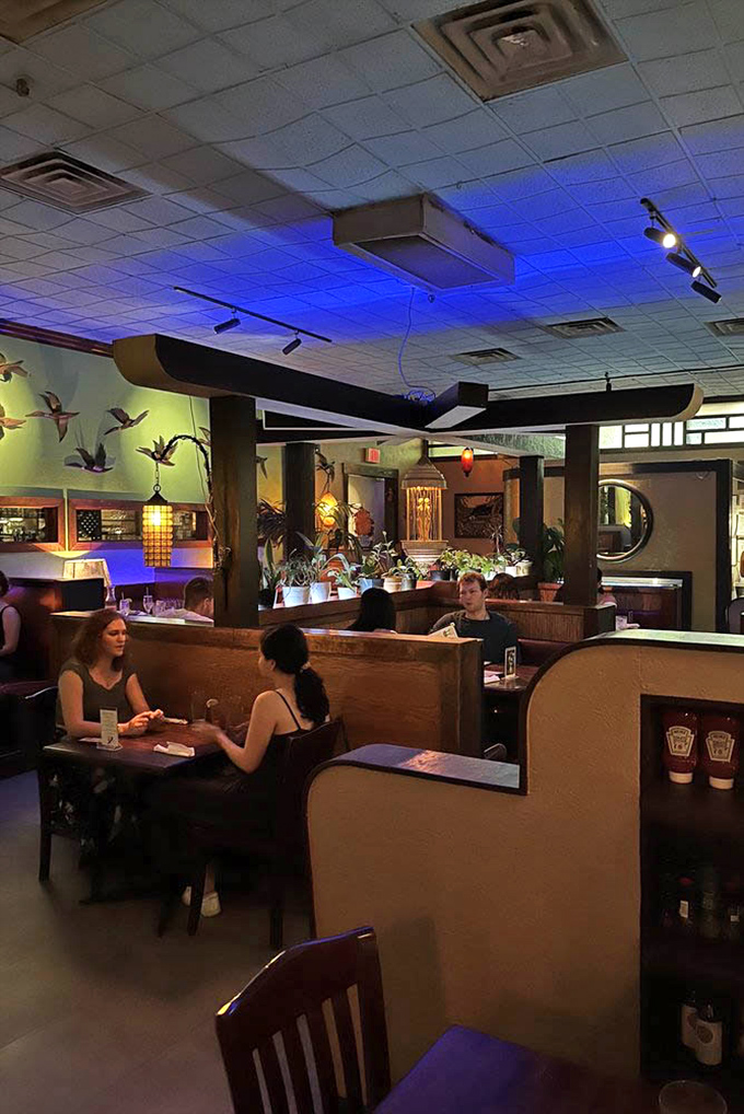 The dining room buzzes with conversation, each booth a private island in a sea of culinary delight.