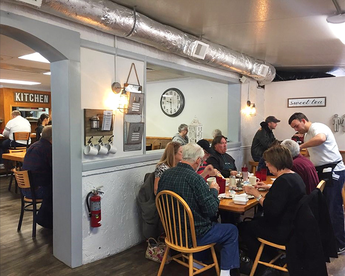 The breakfast club in session&mdash;locals gathering for their daily ritual of coffee and conversation. Community served alongside pancakes.