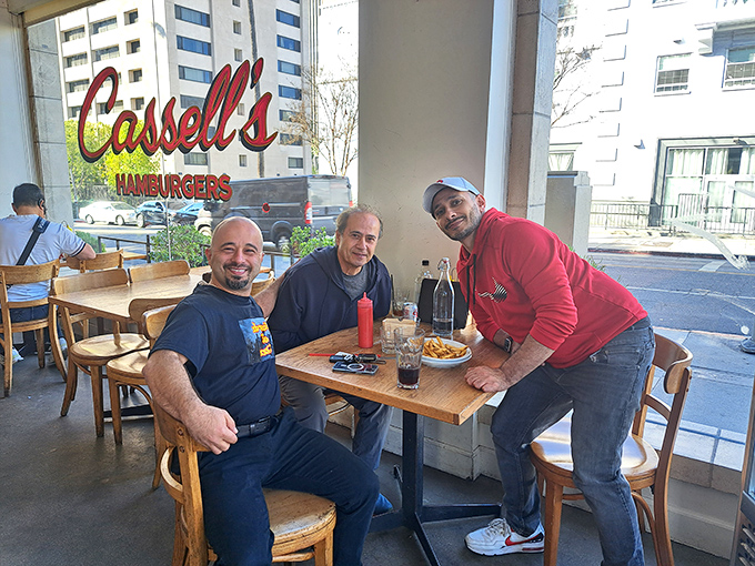 Three happy diners enjoying the simple pleasure of good food and conversation&mdash;the universal language spoken fluently at Cassell's.