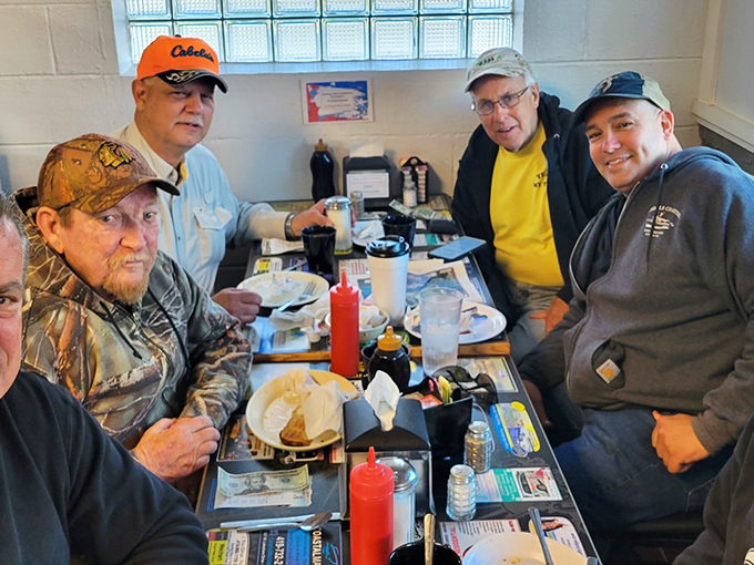The morning regulars' table, where local news travels faster than the coffee refills. These gentlemen have solved all of Port Clinton's problems by 9 AM.