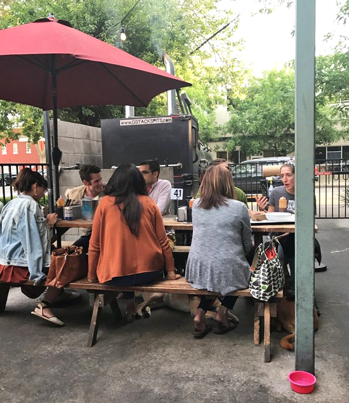 The outdoor seating area isn't just practical&mdash;it's where barbecue memories are made, sauce-stained napkins pile up, and friendships deepen.