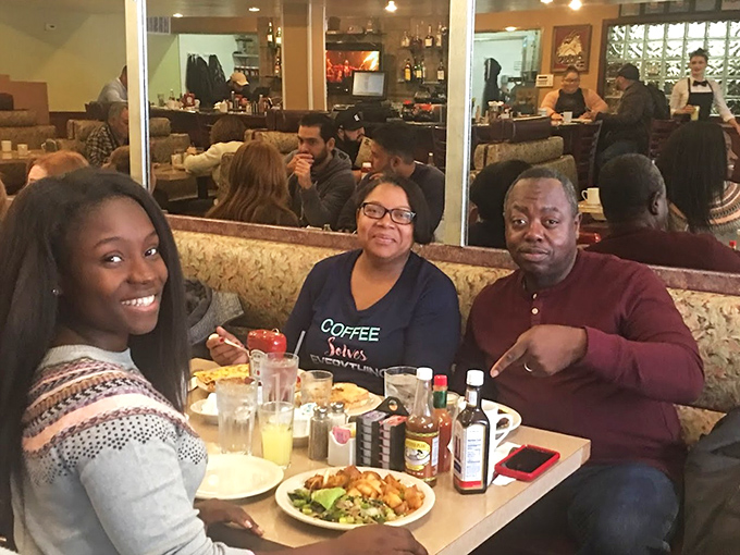 Happy diners sharing a moment of breakfast bliss&mdash;the universal expression of "I made the right life choice coming here today" written across their faces.