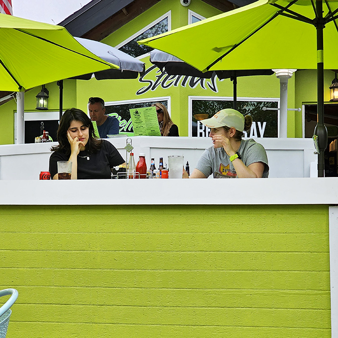 The outdoor dining area: where breakfast meets fresh air and good conversation. Under Stella's lime umbrellas, even Monday mornings feel hopeful.