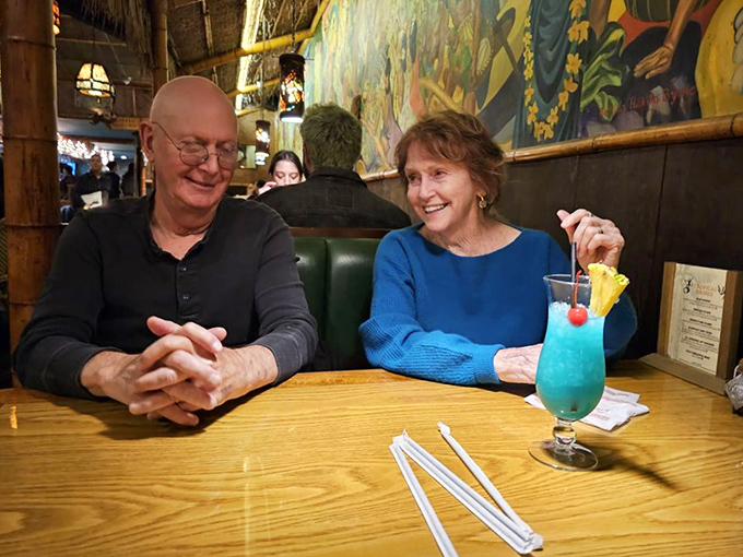 Happy diners and blue tropical drinks—scientific proof that tiki culture and good conversation are the perfect pairing for an evening out.