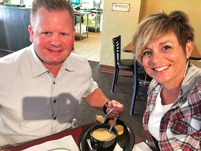 Happy diners sharing a moment over what appears to be soup&mdash;because good food creates memories that outlast the meal itself.