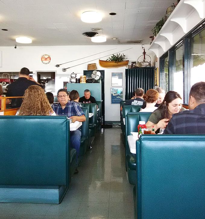 Classic diner booths in that perfect shade of teal&mdash;where strangers become neighbors and everyone's united by the universal language of good food.