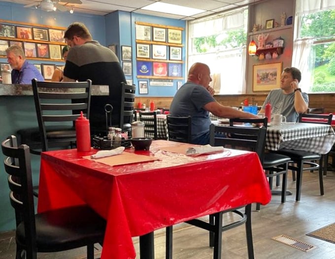 The red tablecloth adds a splash of color to a room where strangers become neighbors over coffee and conversation.