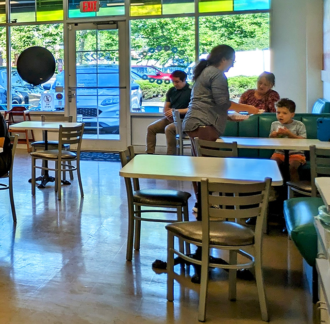 Donna's welcoming interior creates a space where families gather to share sweet moments. The colorful stained glass above the entrance adds a touch of whimsy.