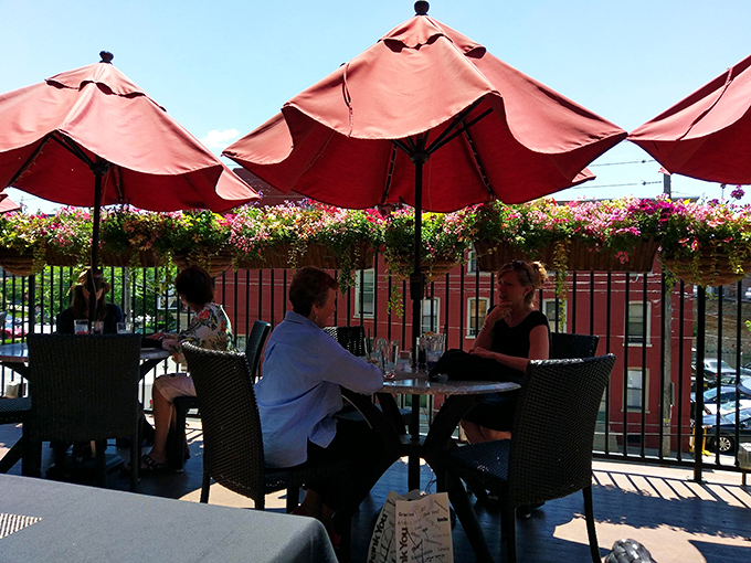 The outdoor dining area offers a front-row seat to Lancaster life under cheerful red umbrellas. Romance and people-watching, served alongside your meal.