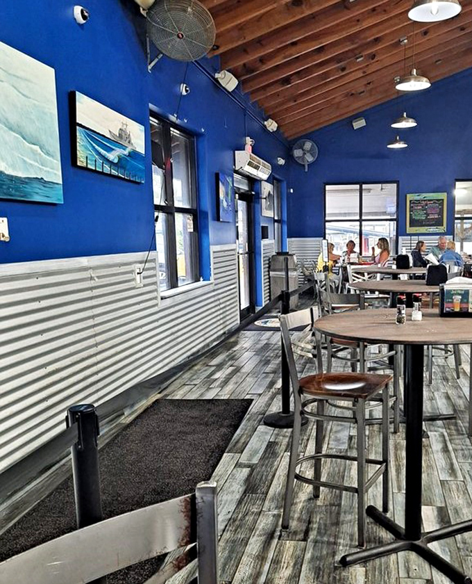 Vibrant blue walls and corrugated metal create that perfect "you've discovered something special" atmosphere that seafood shacks do best.