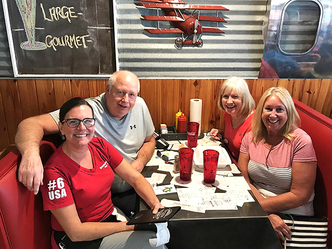 Happy diners in their natural habitat, proving that good food creates the kind of smiles no Instagram filter can replicate.