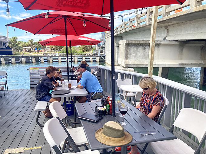 Waterfront dining with red umbrellas&mdash;where conversations flow as smoothly as the Intracoastal waters just a few feet away.