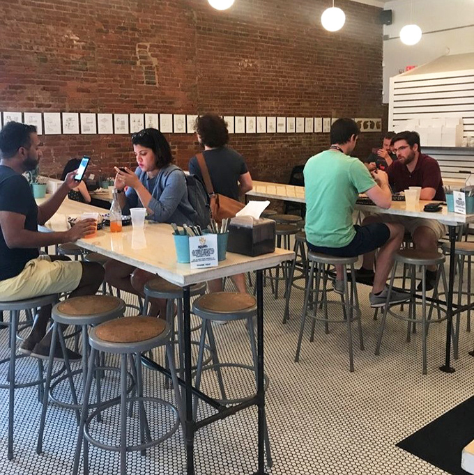 The universal language of good food: heads bowed in reverence over meals that demand full attention.