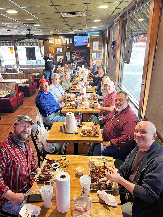 Not just a meal, but a gathering of the BBQ faithful. Those paper towel rolls aren't decorative&mdash;they're essential equipment.