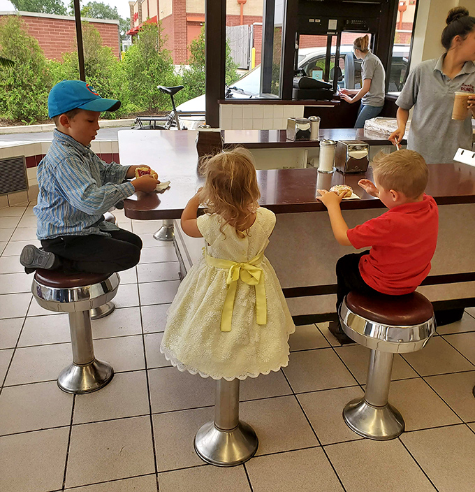 Childhood donut dreams coming true on swivel stools. That little girl in her party dress knows fancy when she sees it—and it's right there on her plate.