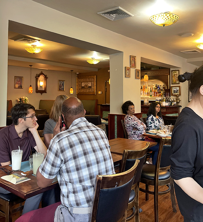 The dining room buzzes with conversation as patrons experience their own moments of culinary delight. Community formed through shared good taste.