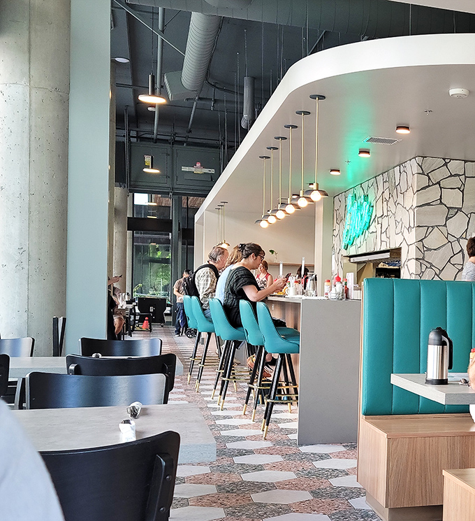 The sleek counter seating at Glo's new digs offers front-row tickets to the breakfast show, with turquoise chairs adding a pop of color to your morning routine.