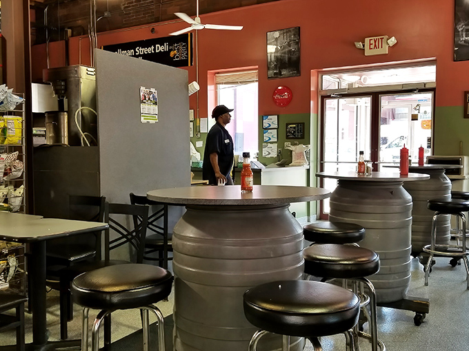 Barrel tables and industrial stools create a no-nonsense dining space where the food, not the furniture, deserves your full attention.