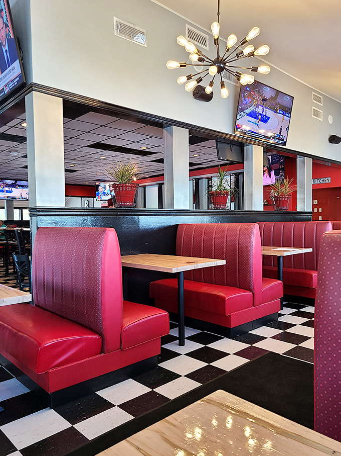 Red booths against checkerboard floors create that classic American diner feel, but the aroma tells you this is serious BBQ territory.
