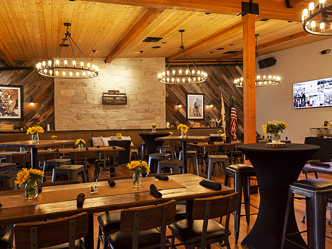 Rustic elegance with wooden beams and circular chandeliers. Even the sunflowers seem to be celebrating what's about to happen on those tables.