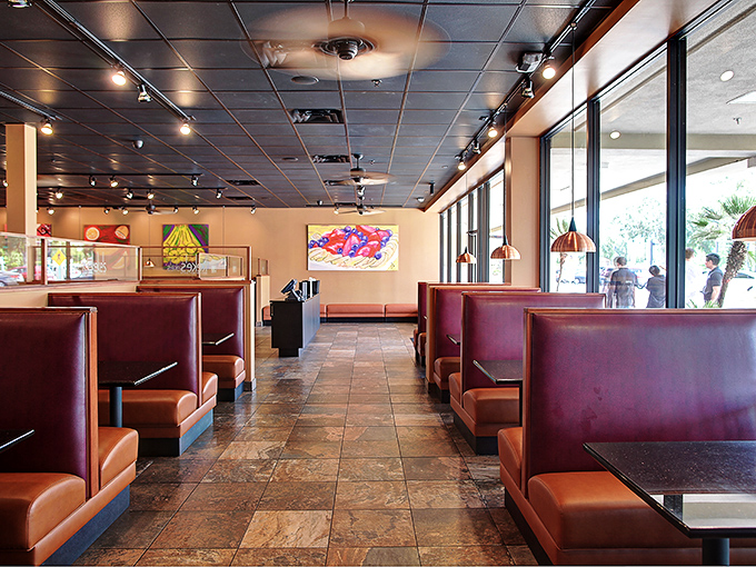 The dining room's warm lighting and colorful artwork create that rare space where both early birds and those dragging themselves in at noon feel equally welcome.