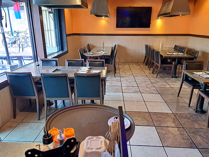 The dining room balances functionality with warmth&mdash;each table equipped with its own grill, ready for the meat parade to begin.