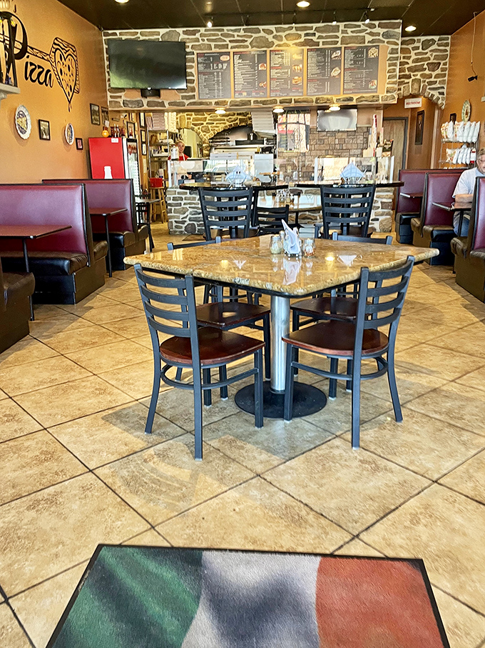 The dining area says "stay awhile" with its cozy booths and Italian flag welcome mat&mdash;comfort before the comfort food.