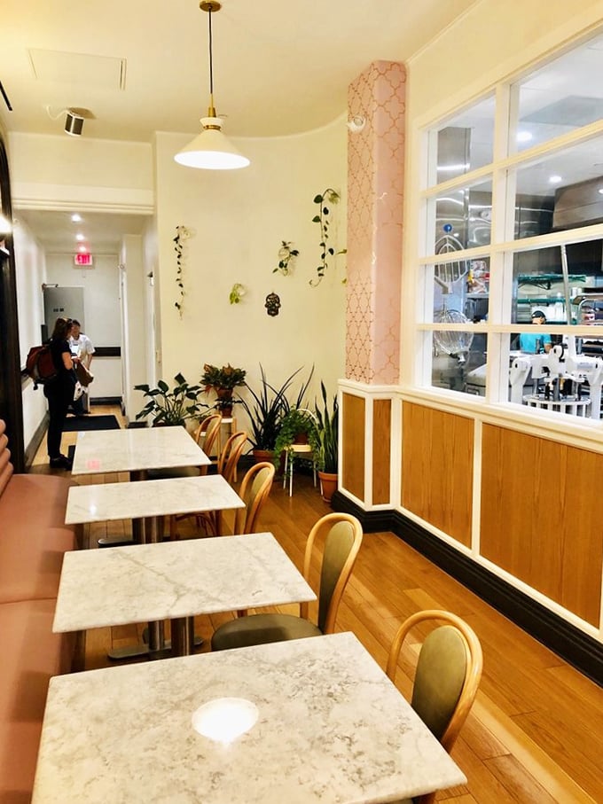 Pink accents, marble tables, and thoughtful design touches create a dining space where you'll want to linger long after your Jerusalem bagel is just a delicious memory.