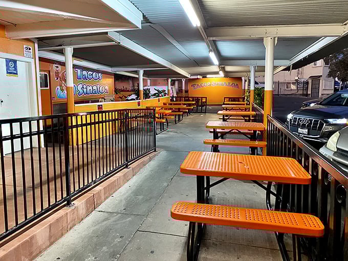 The covered dining area offers a no-frills spot to worship at the altar of great tacos. Orange tables match the truck&mdash;commitment to branding or happy accident?