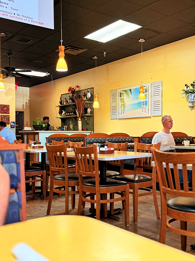 Yellow walls and pendant lighting create the kind of warm atmosphere that makes strangers into neighbors over plates of French toast.