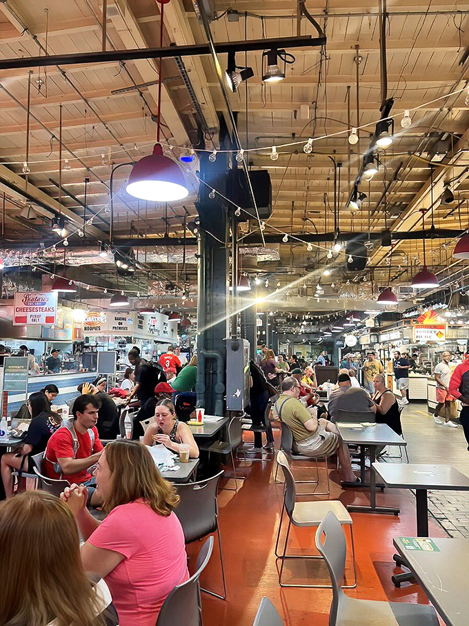 Reading Terminal Market's communal dining area buzzes with the energy of food lovers. String lights overhead add a touch of magic to this culinary playground.