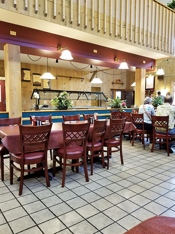 The dining area offers no-nonsense seating for serious pastry contemplation. Those wooden chairs have supported countless sugar-induced epiphanies.