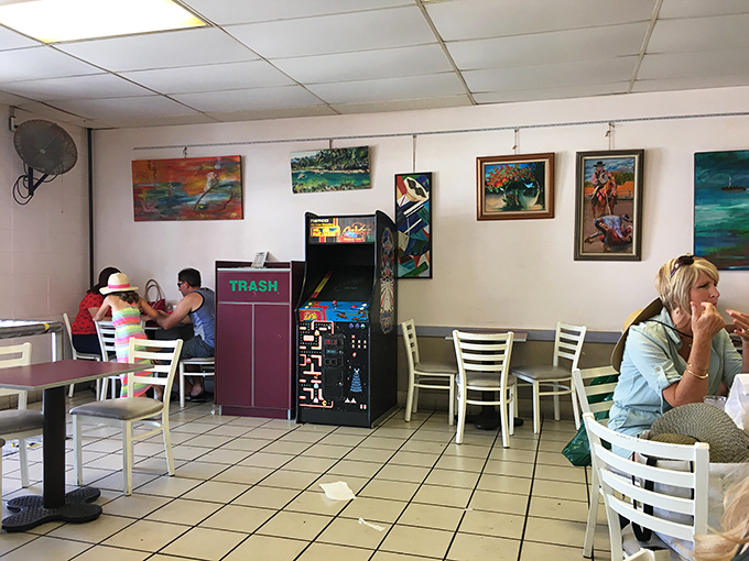 The dining area: where strangers become friends united by sticky fingers and sugar-induced grins. Note the vintage arcade game&mdash;dessert and entertainment!