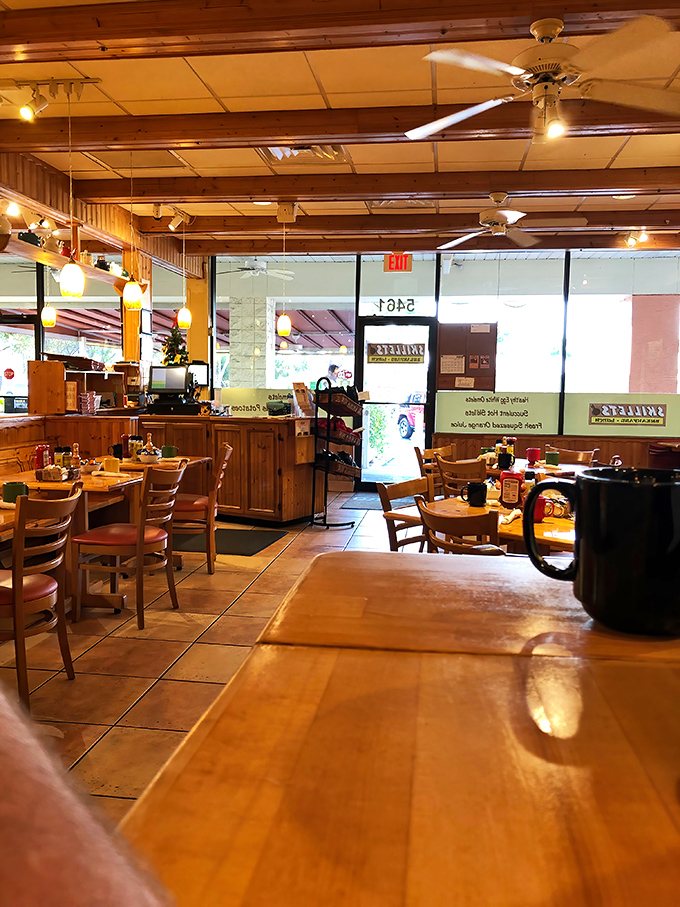 The dining area balances rustic charm with clean simplicity. Those ceiling fans keep the Florida heat at bay while you focus on the important stuff &ndash; eating.