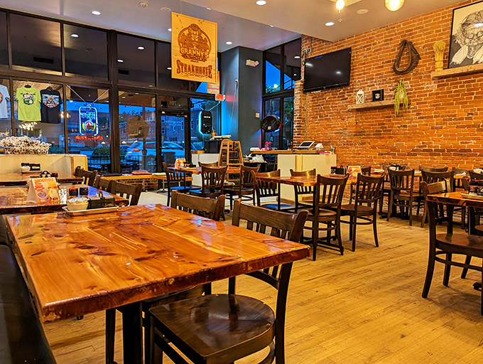 Evening light bathes the dining room in golden hues, turning wooden tables and exposed brick into something from a Norman Rockwell painting.