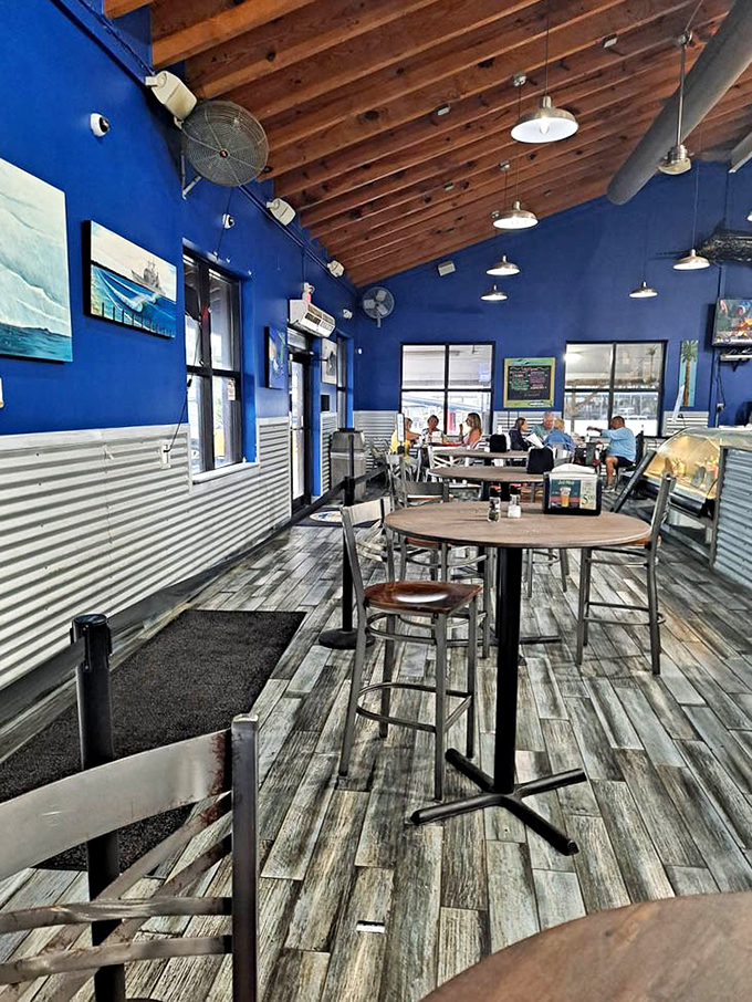 Blue walls and weathered wood floors tell stories of countless seafood feasts. The metal chairs say "we care about the food, not your lumbar support."