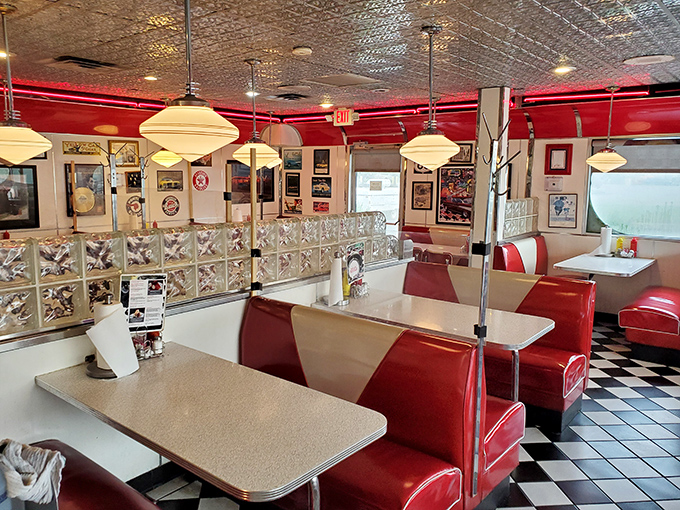Red booths beckon like old friends, while pendant lights cast the kind of glow that makes everyone look like they're in a Norman Rockwell painting.