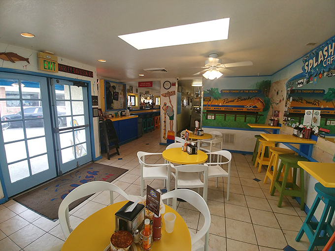 The dining area's cheerful yellow tables and coastal blue accents create the perfect backdrop for the seafood drama about to unfold.