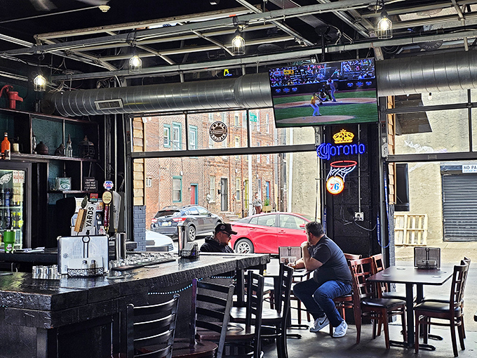 The bar area doubles as front-row seating for both sports and sandwich appreciation, with TVs strategically placed for maximum enjoyment.